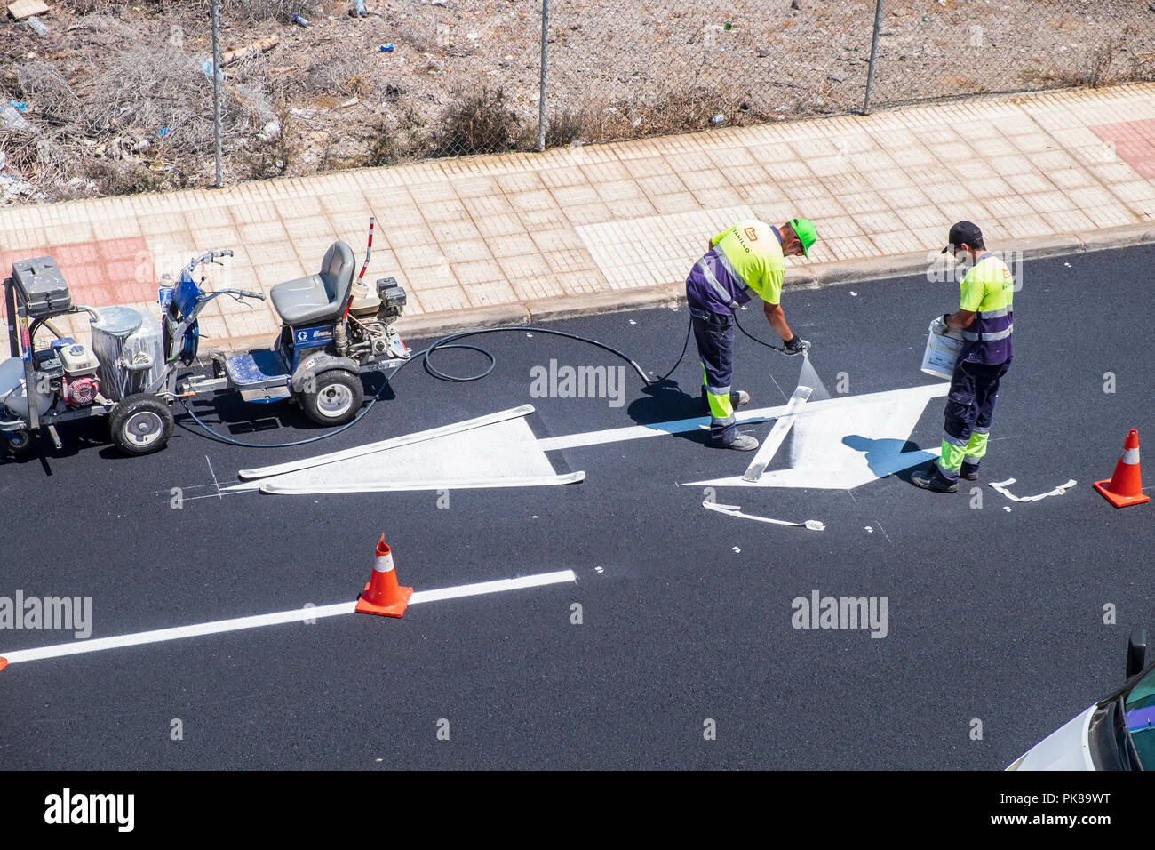 Painting new road markings on a newly resurfaced road Stock Photo - Alamy