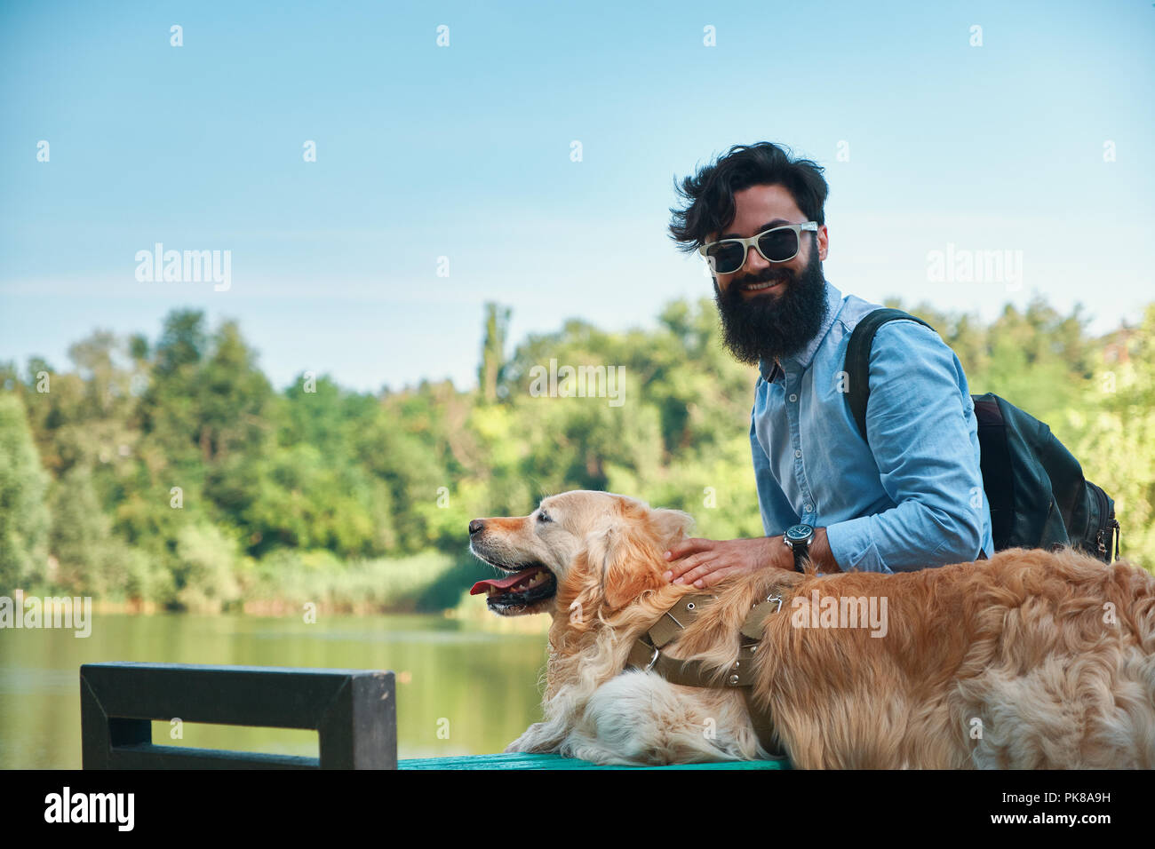 Best friends' concept - between human and animal. Side view, young man ...
