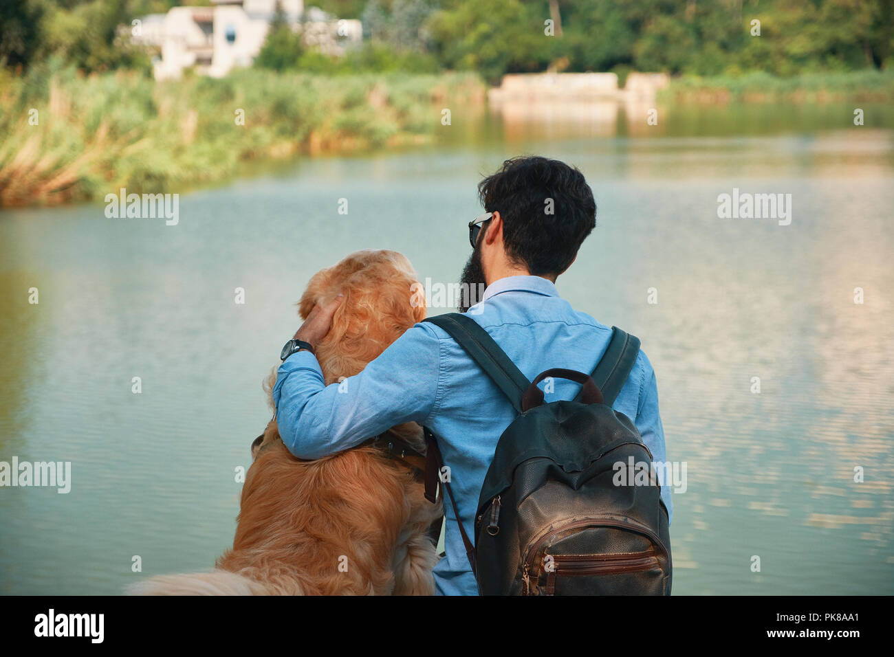 Best friends' concept - between human and animal. Back view, young man ...