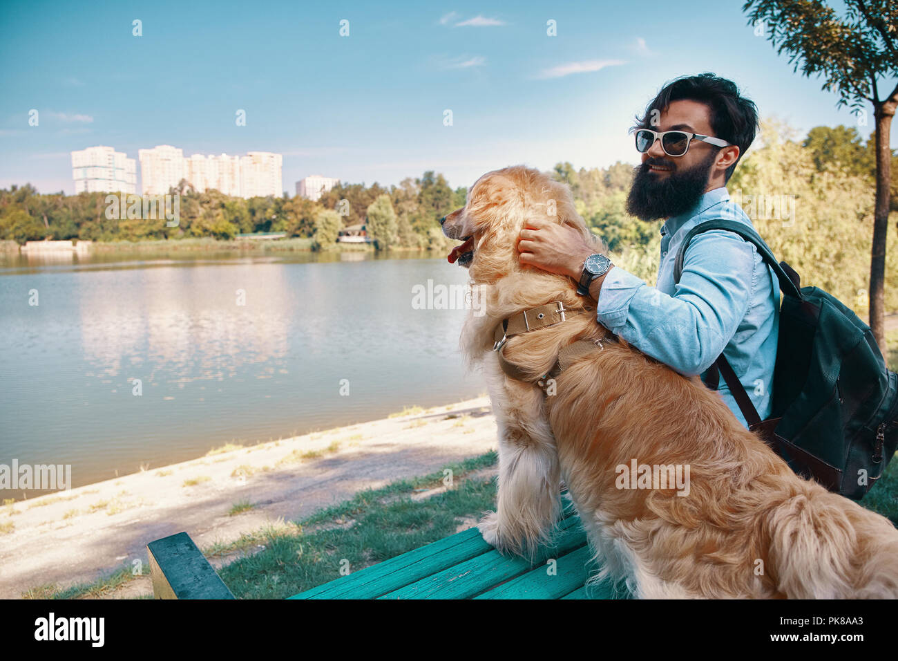 Best friends' concept - between human and animal. Angle view, young man ...