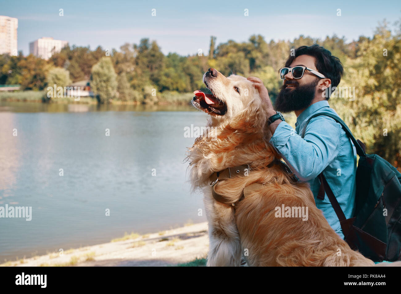Best friends' concept - between human and animal. Angle view, young man ...