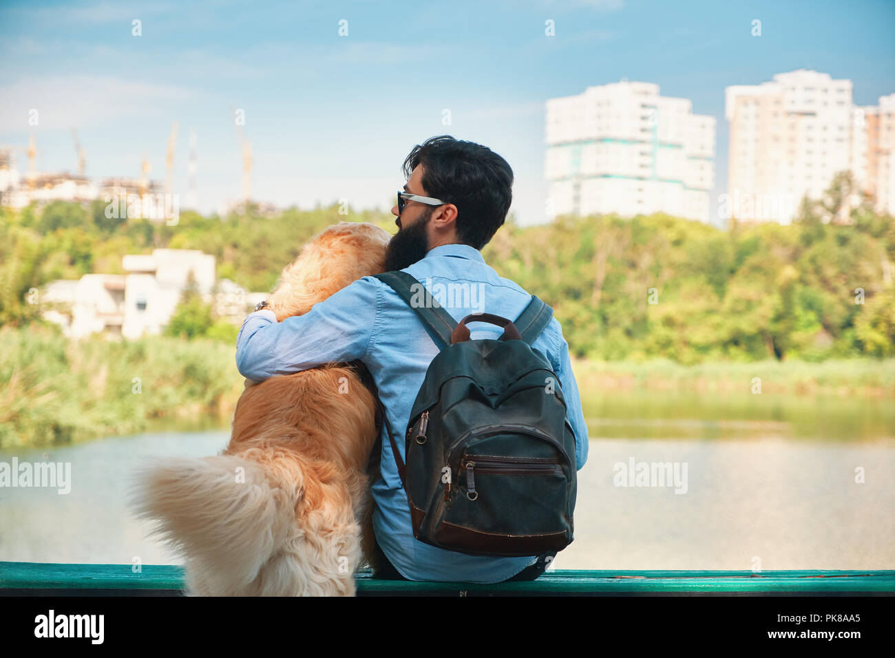 Best friends' concept - between human and animal. Back view, young man ...