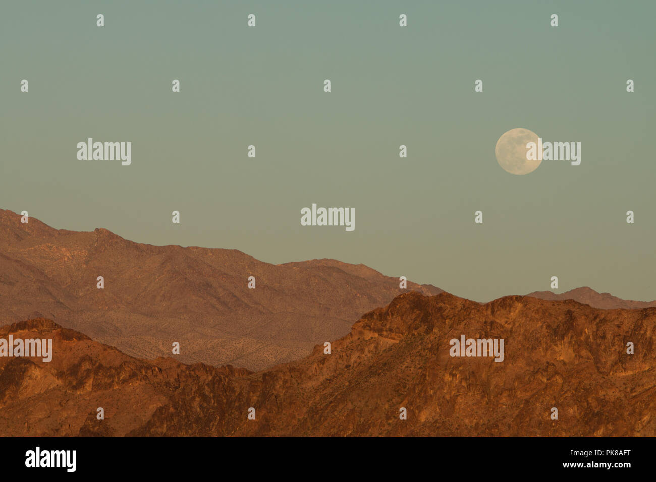 Moon rising as sun is setting Stock Photo - Alamy