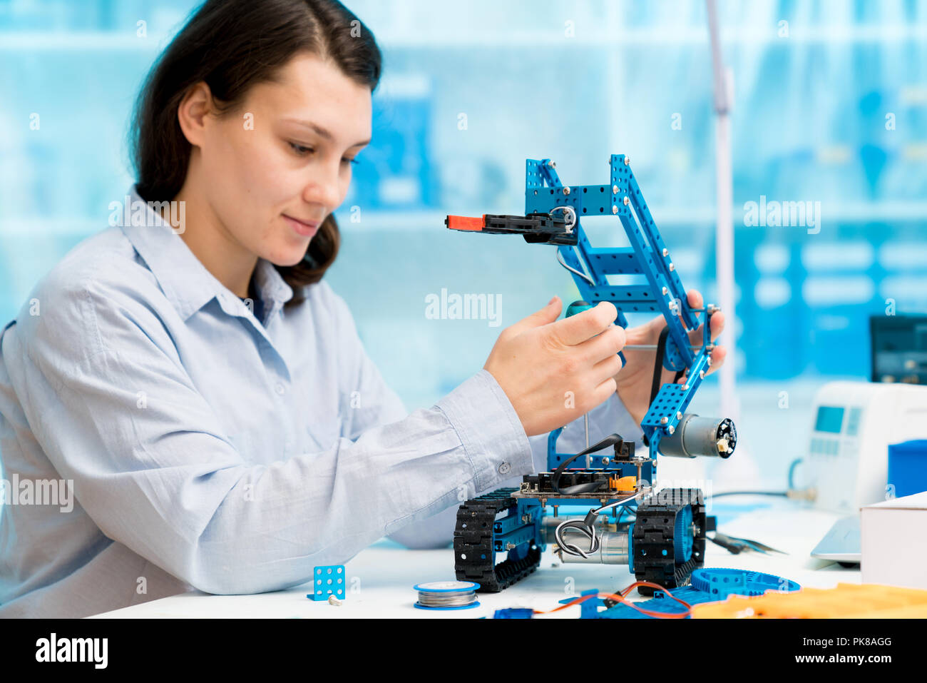 Student girl in electronics laboratory, experiment with microcontroller ...