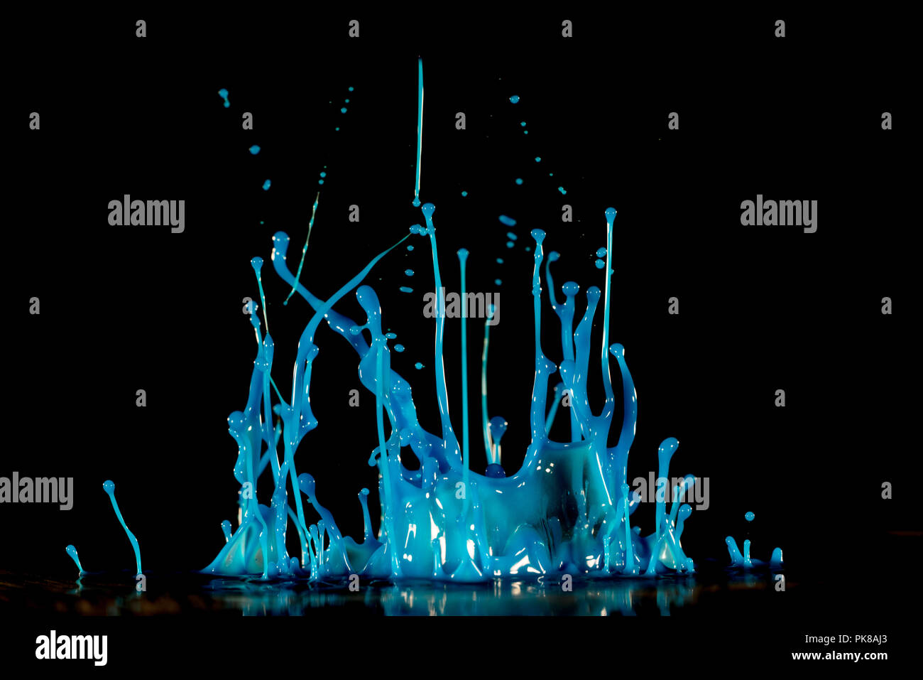 Blue paint, ink splash on black background Stock Photo - Alamy