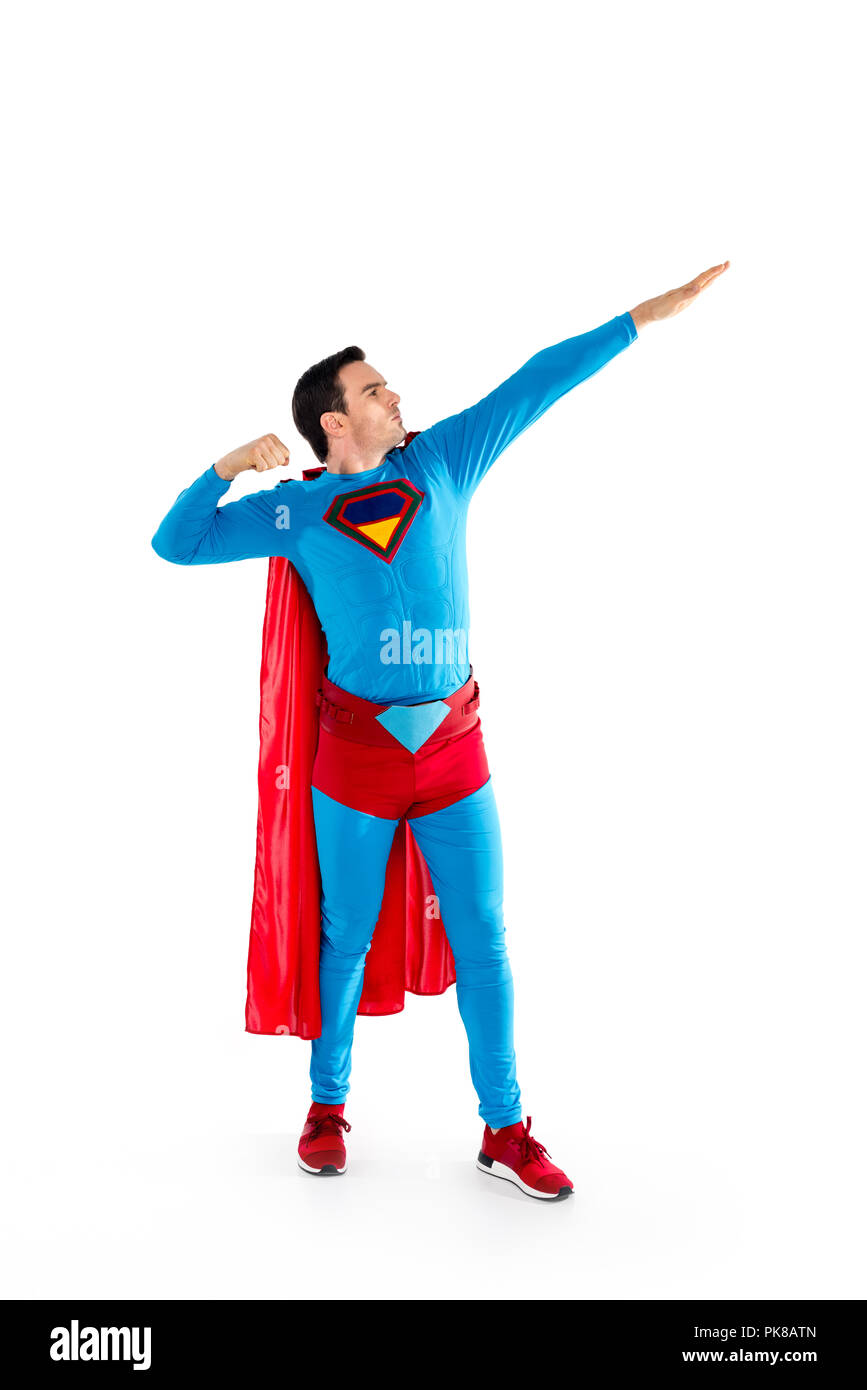 full length view of handsome man in superhero costume looking away ...