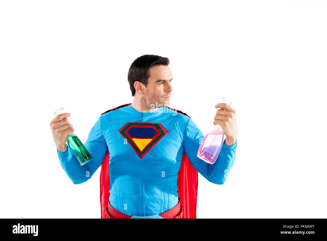 handsome superhero holding plastic spray bottles with cleaning liquid ...
