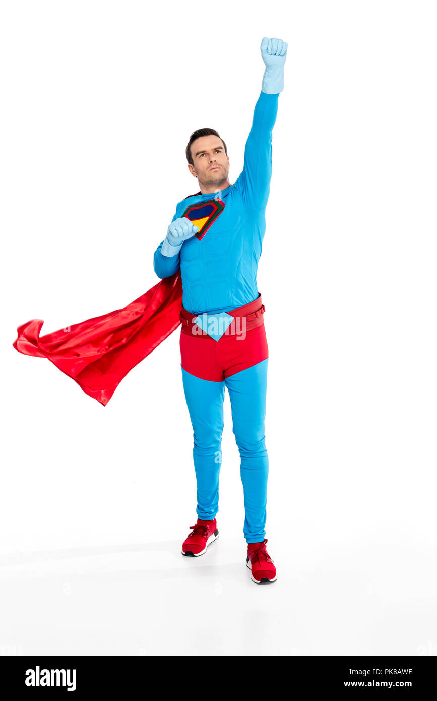 full length view of male superhero in rubber gloves raising hand and ...