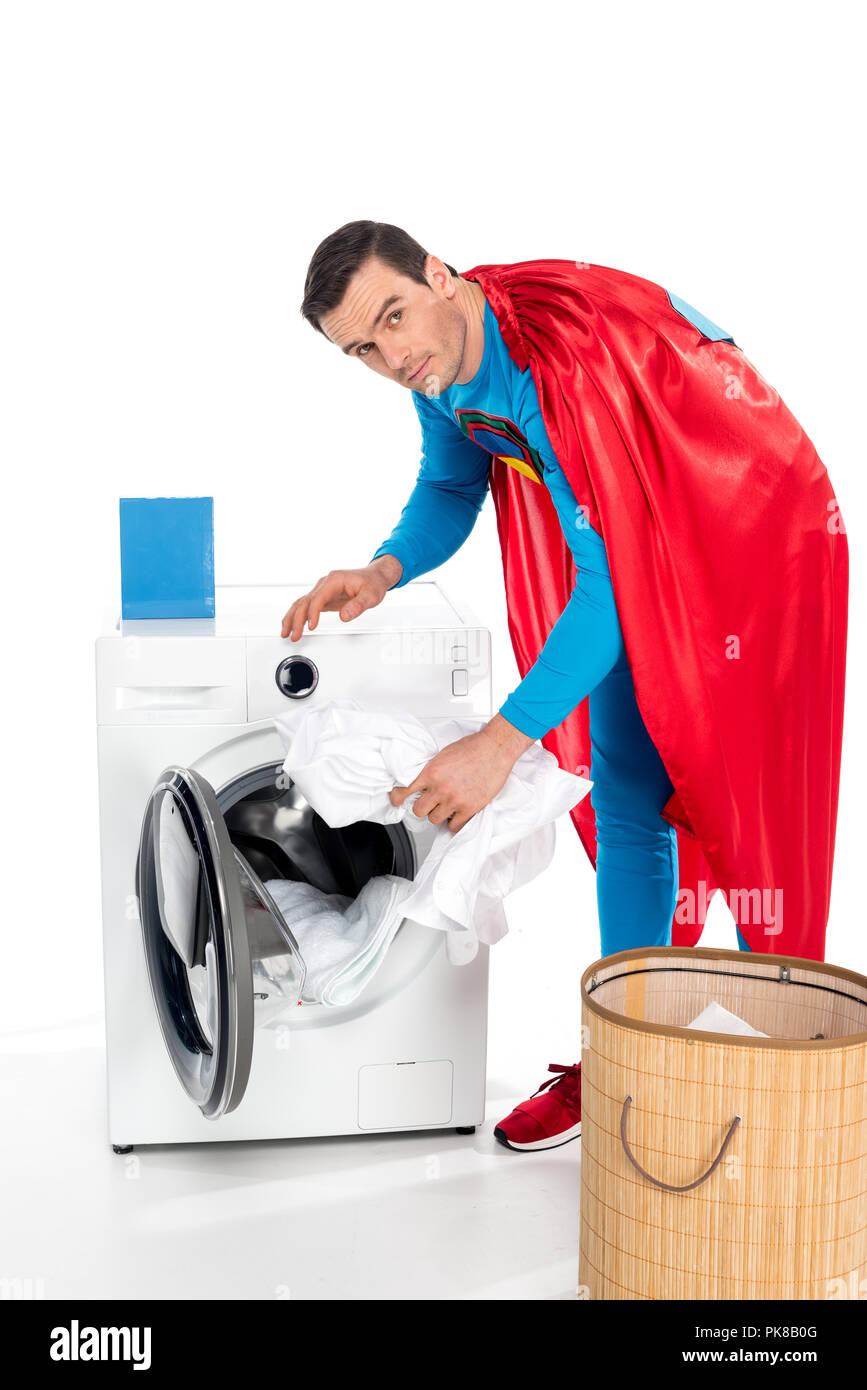 washing clothes in washing machine and looking at camera on white Stock ...