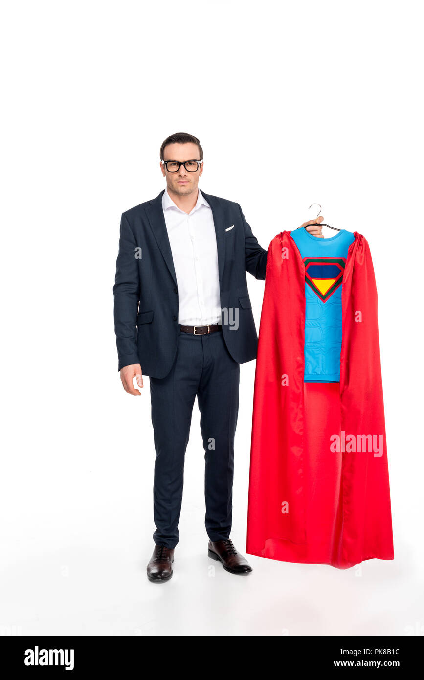 businessman in eyeglasses holding hanger with superhero costume and ...