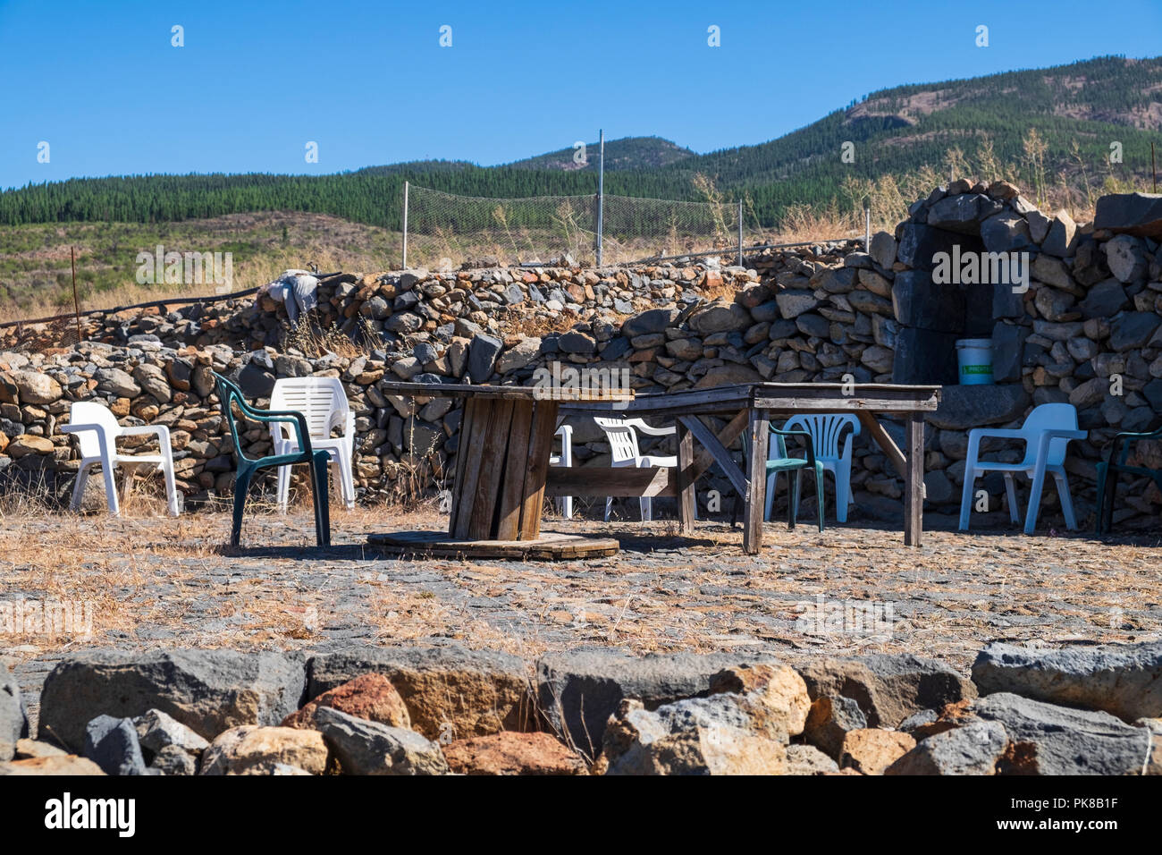 Era or threshing floor with chairs and makeshift tables in a remote ...