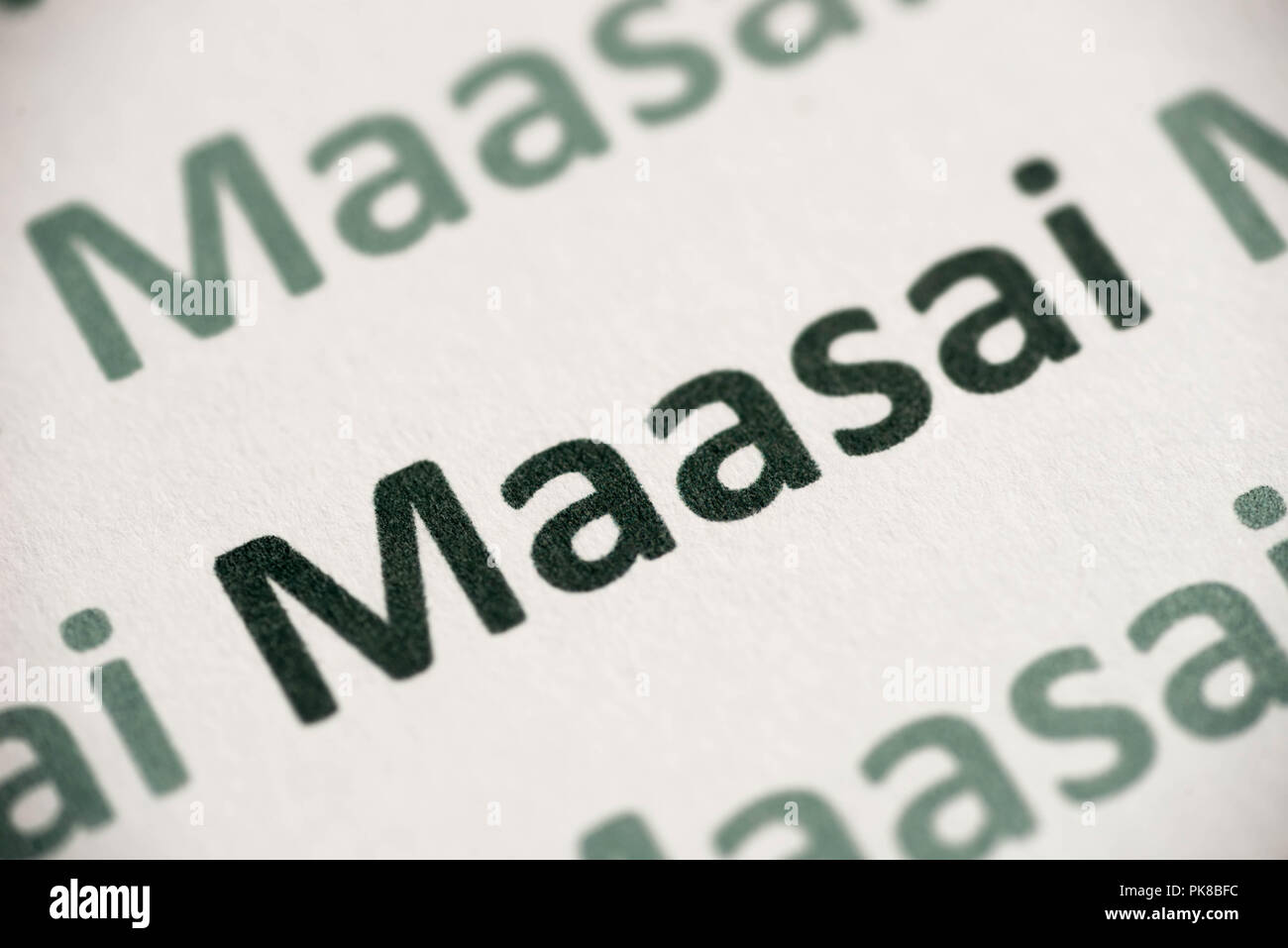 word Maasai language printed on white paper macro Stock Photo - Alamy