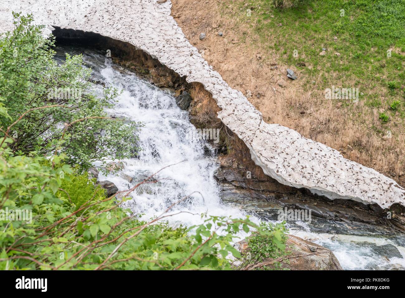 Remains of the ice cover and snow cover over a mountain stream in ...