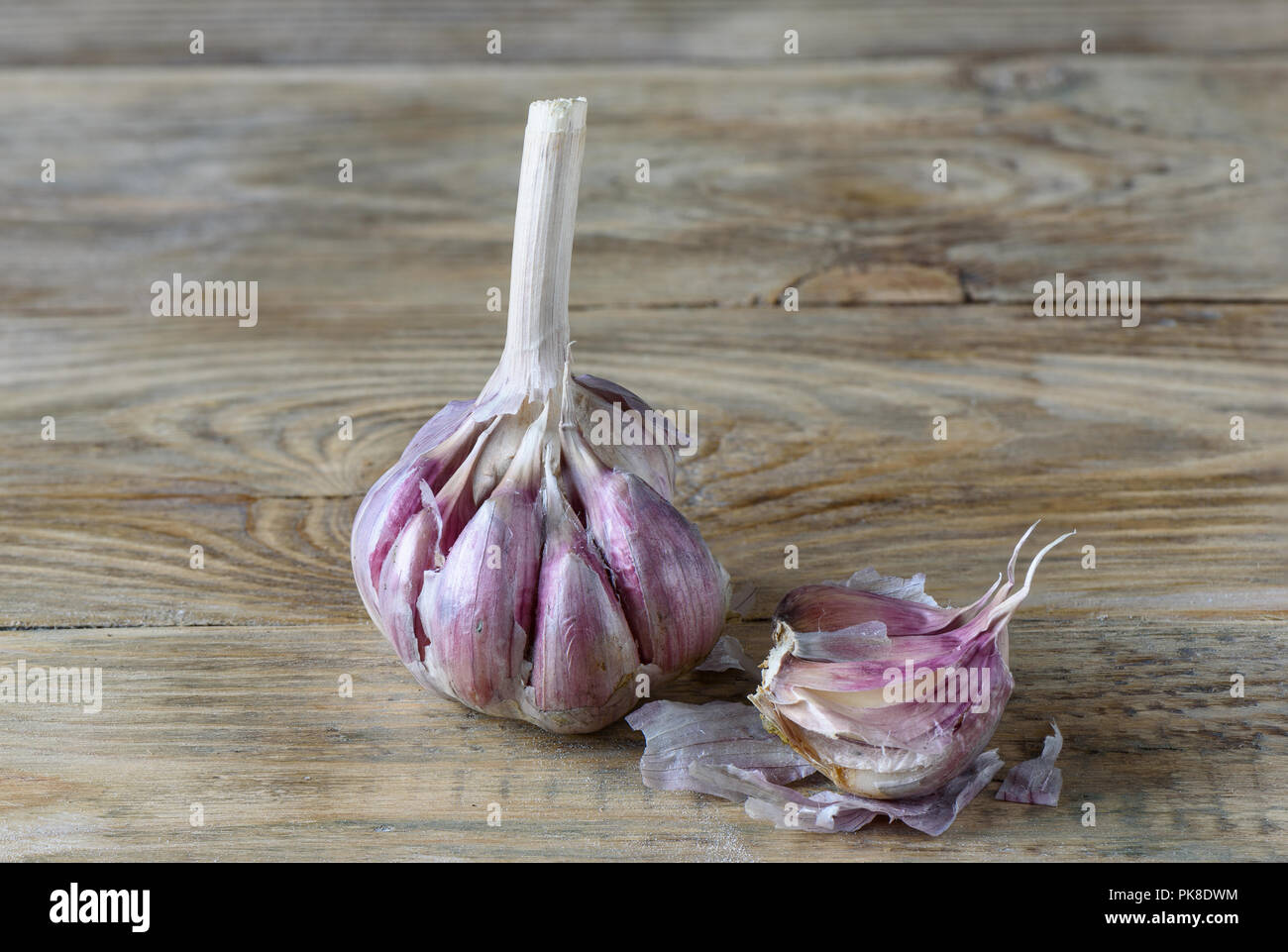 Rustic style. Garlic and a few cloves of garlic on a wooden kitchen ...