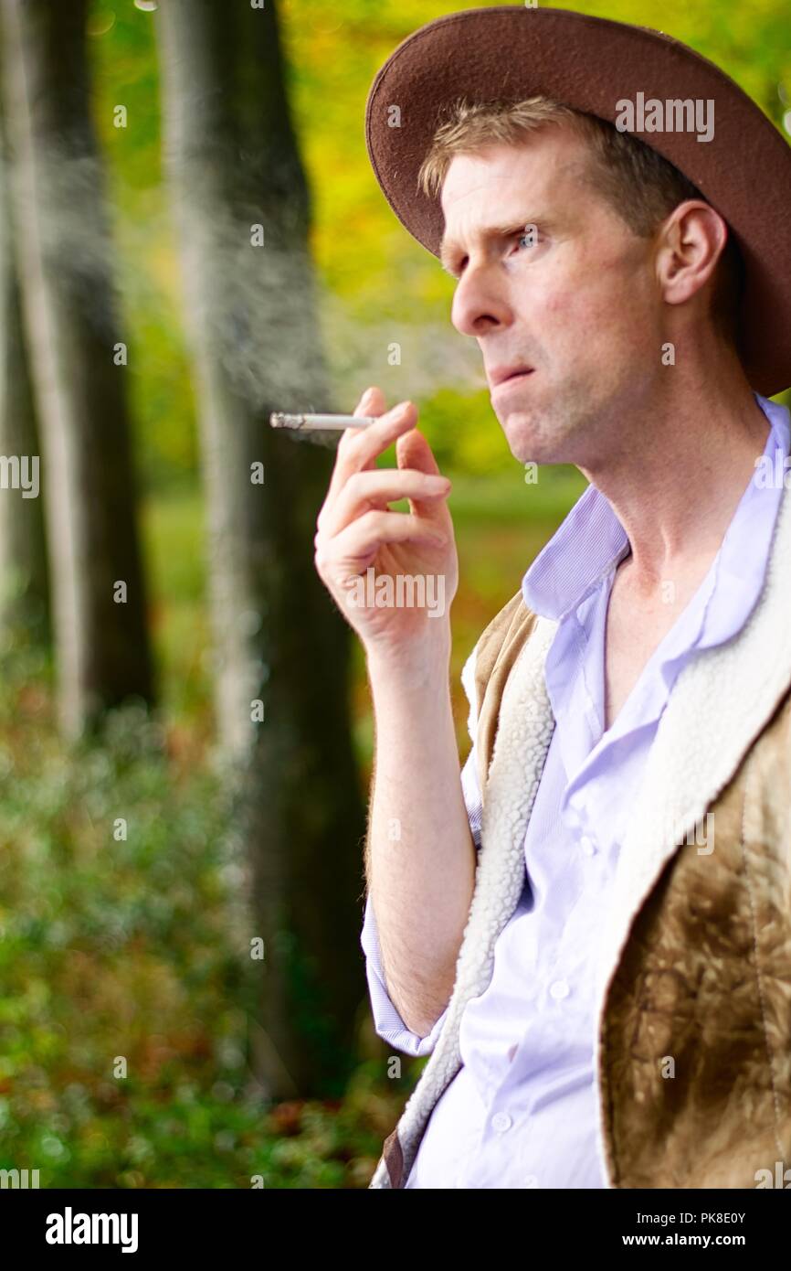 Cowboy smoking cigarette hi-res stock photography and images - Alamy