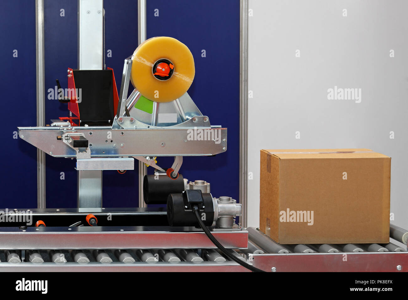 Automated packaging machine for boxes at factory Stock Photo - Alamy