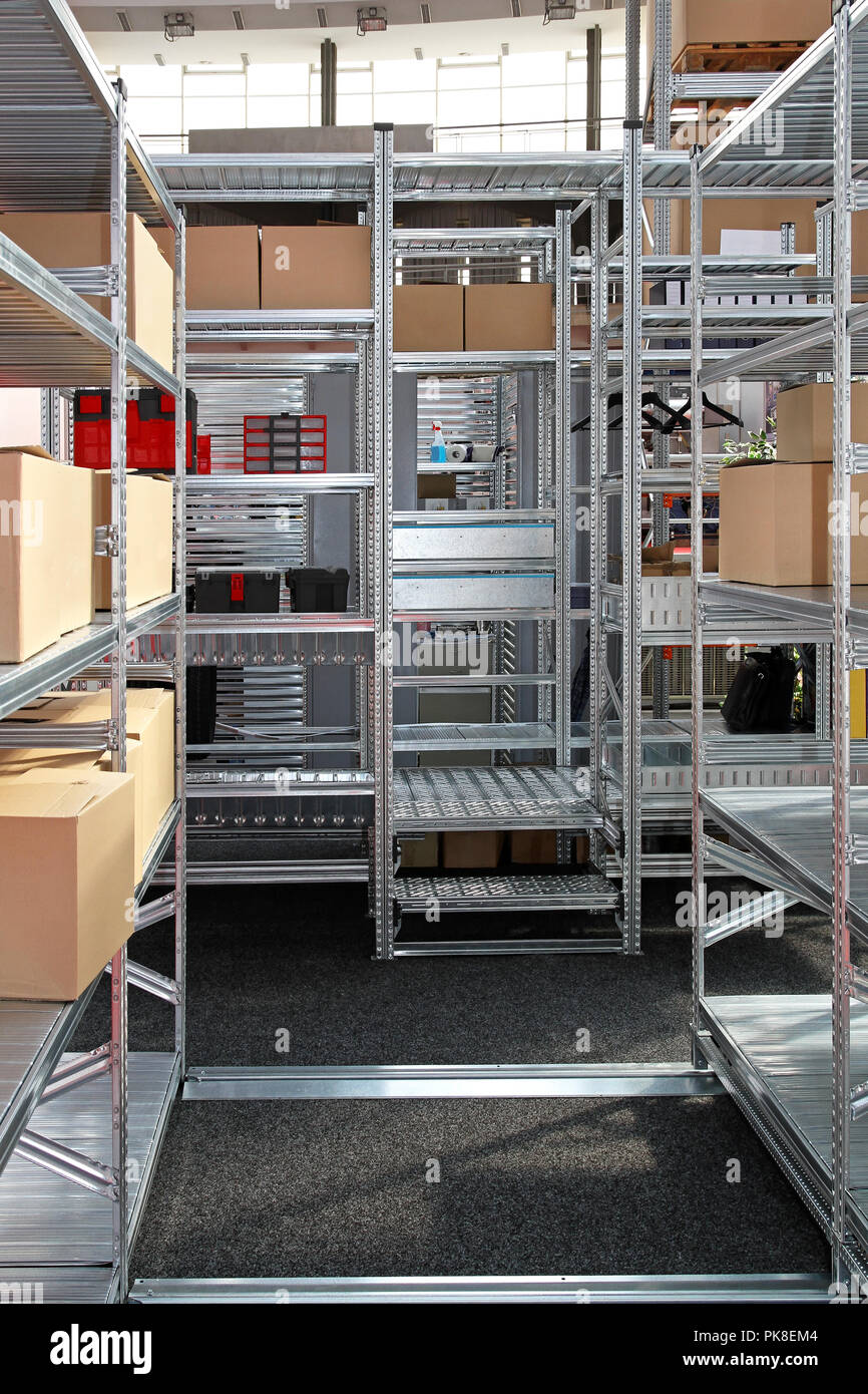 Metal shelving system with boxes in storehouse Stock Photo - Alamy