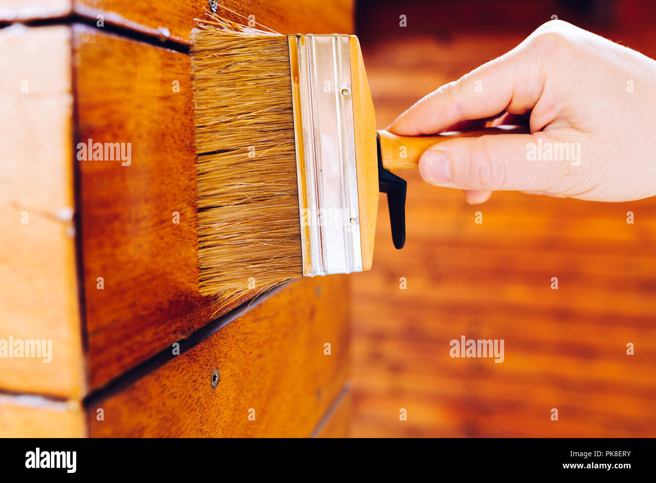 Male hand painting wooden wall with a brush - painting woodwork outside ...