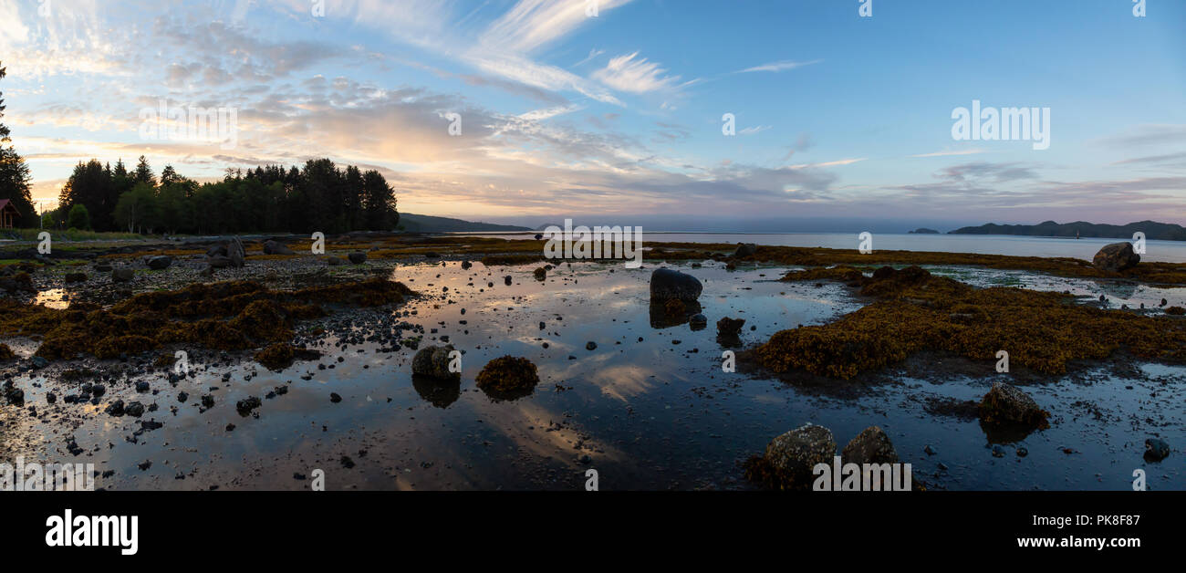 Beautiful panoramic view of a rocky beach during a vibrant cloudy ...