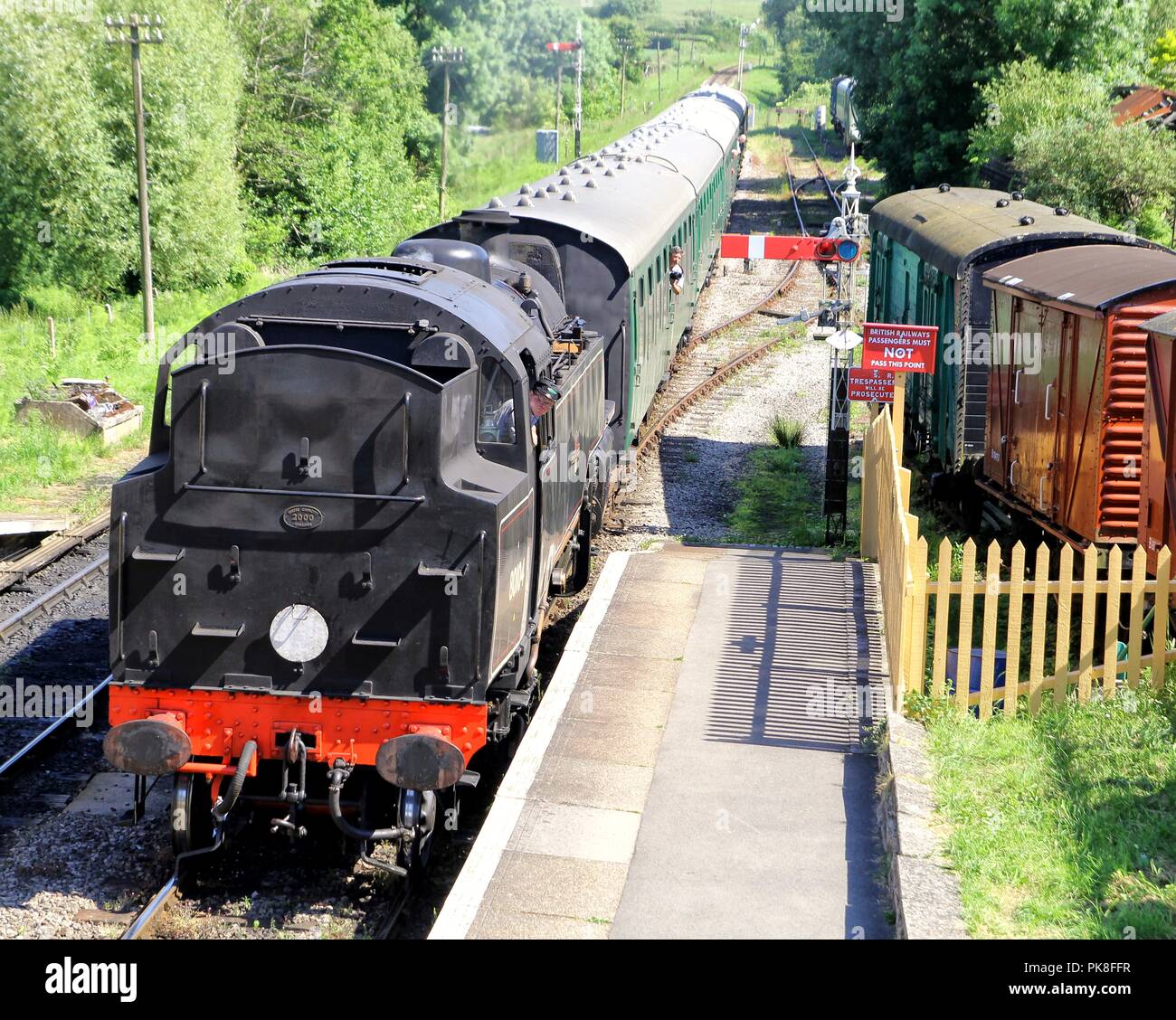 Corfe, England - June 03 2018: Steam engine pulling a passenger train ...