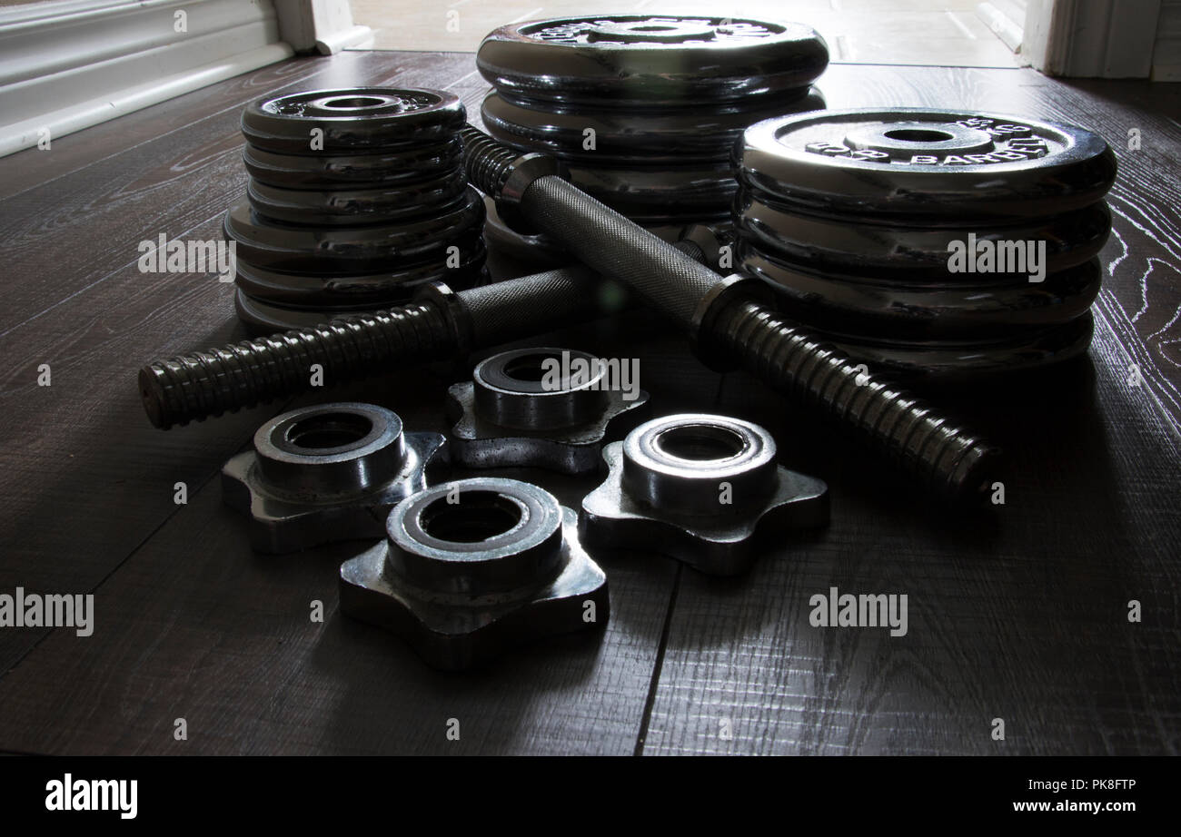 Home fitness equipment on a wood floor. Hard wood floor and Gym tools ...