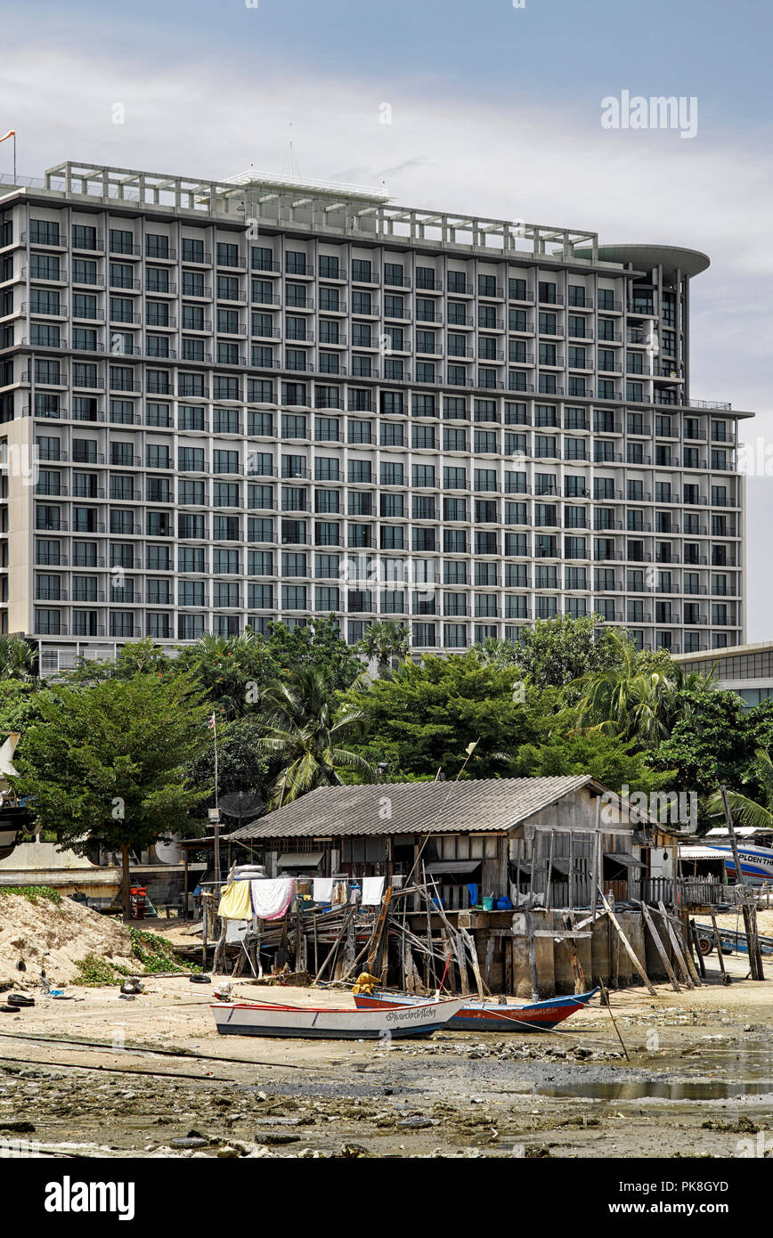 Lifestyle Contrast of a luxury high rise apartment complex dwarfing the ...