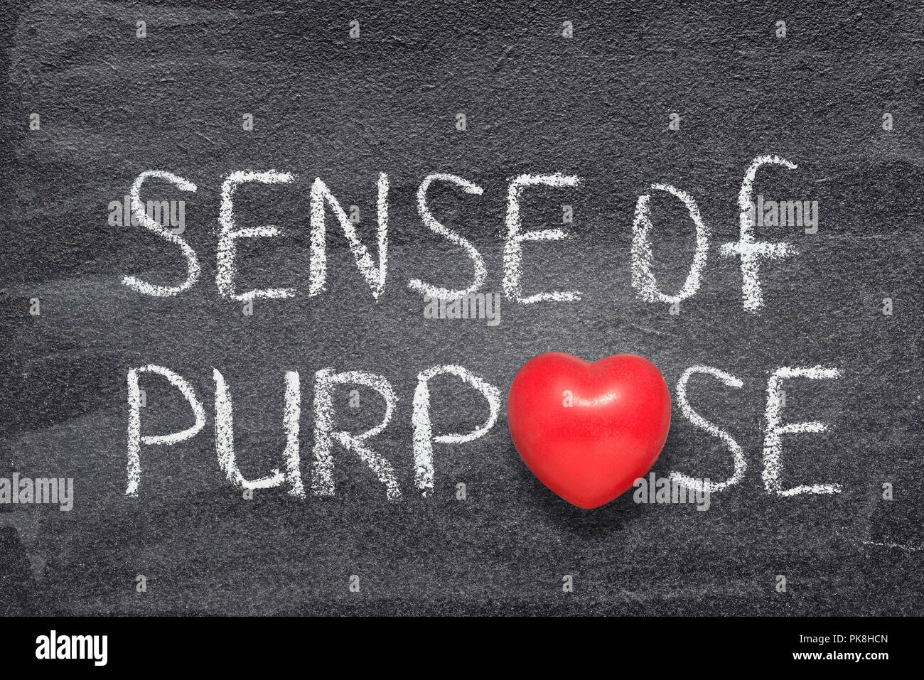 sense of purpose phrase handwritten on chalkboard with red heart symbol ...