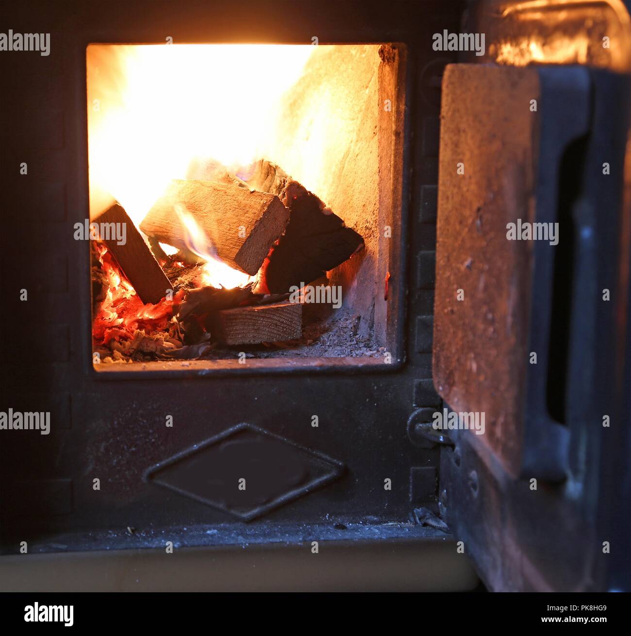 pieces of wood burning inside a stove in a mountain chalet Stock Photo ...