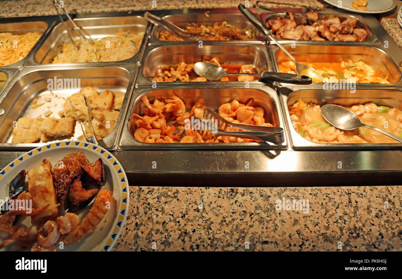 trays with fried food on the counter of a self-service Chinese ...