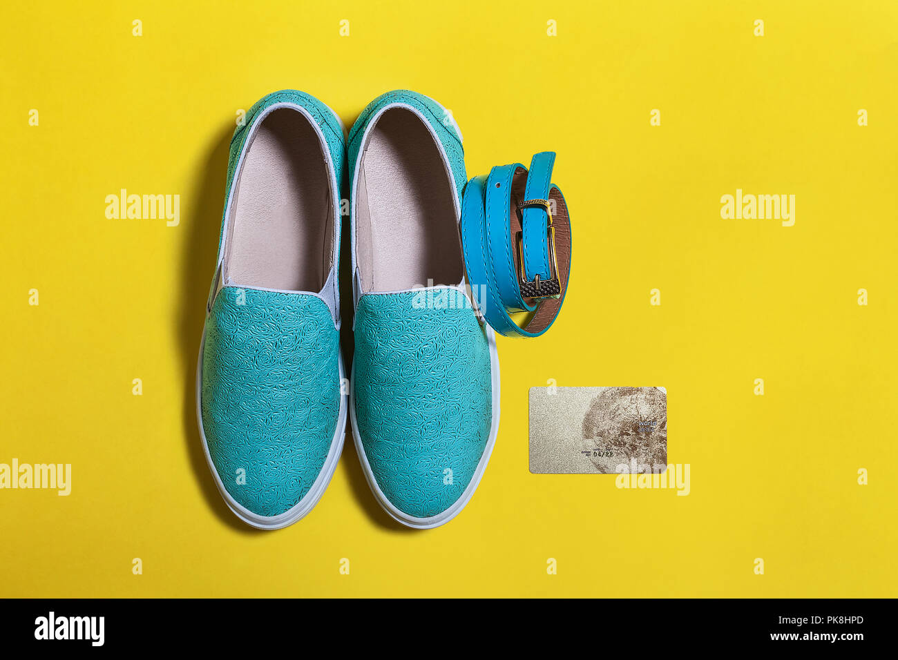 set of stylish women blue slip on shoes, credit card and a belt on the ...