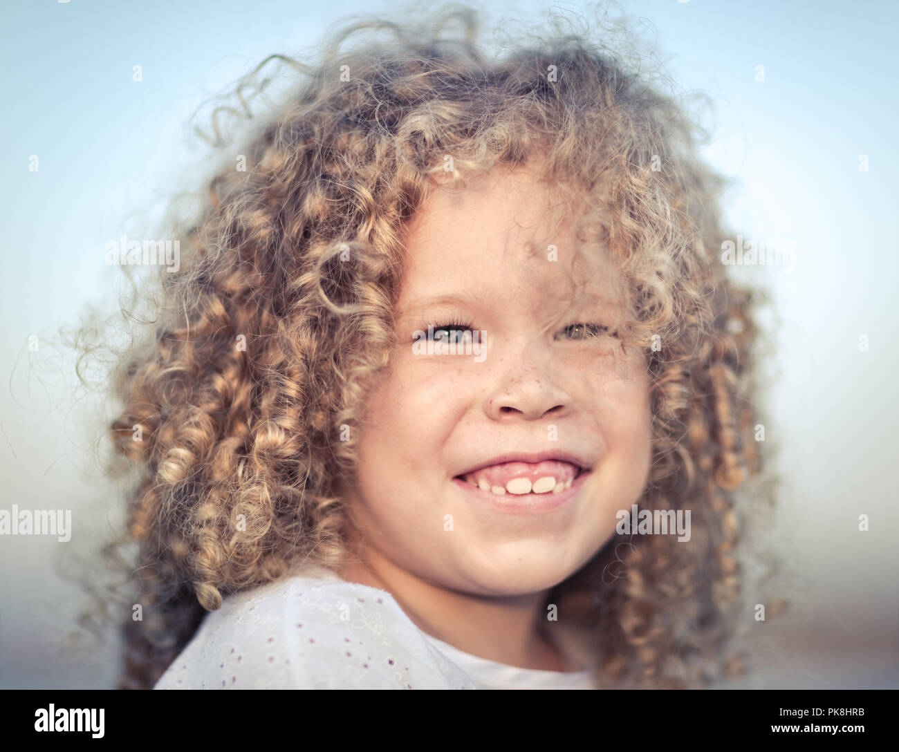 Outdoor portrait of a smiling little girl. Positive emotion concept ...