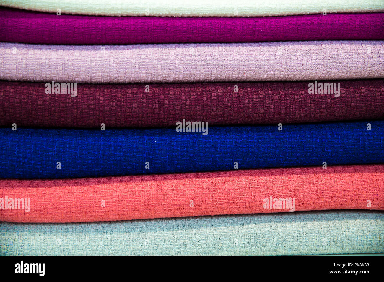 A multicolored stack of fabrics - the fabrics lie on top of each other ...