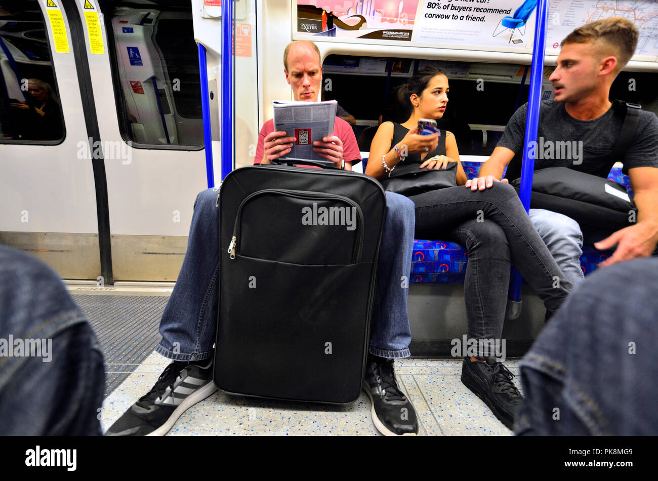 Man train reading newspaper hi-res stock photography and images - Alamy