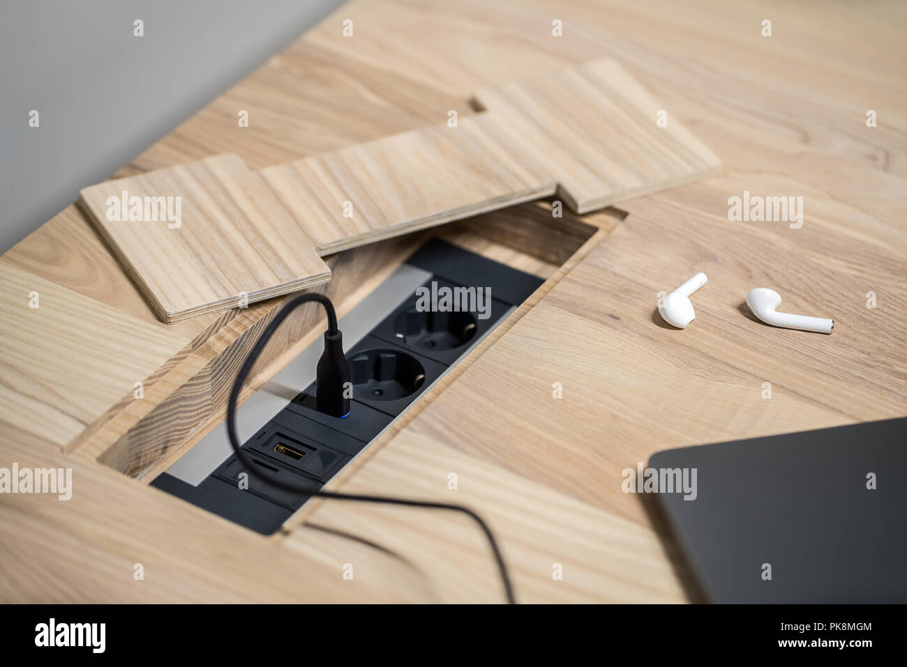 Closeup photo of wooden table with power sockets Stock Photo - Alamy