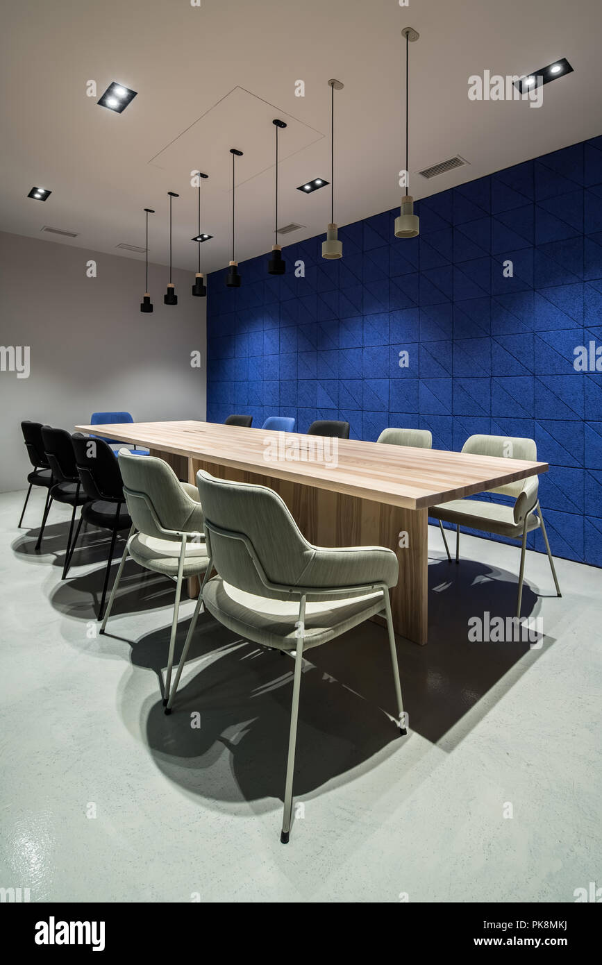 Stylish conference room with gray and blue walls Stock Photo - Alamy
