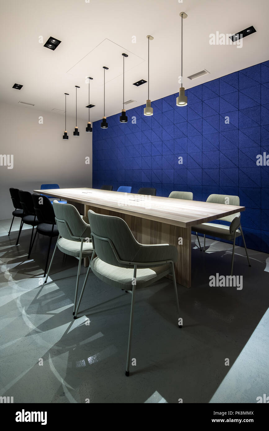 Stylish conference room with gray and blue walls Stock Photo - Alamy