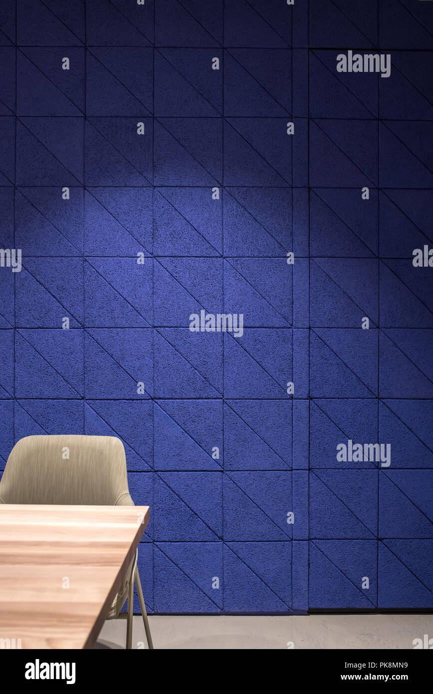 Stylish interior with textured blue wall and furniture Stock Photo - Alamy