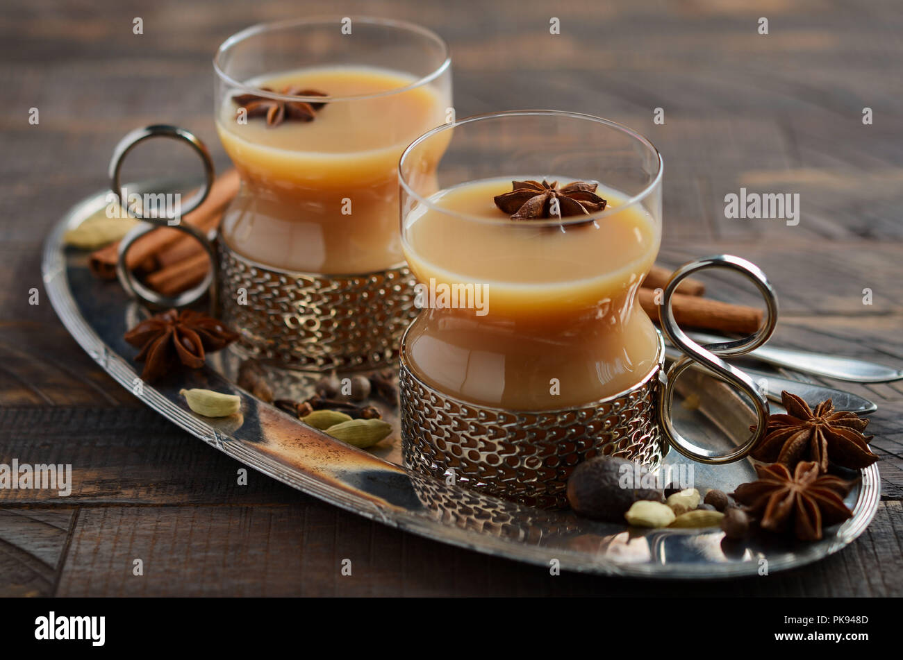 Indian masala chai tea. Spiced tea with milk in a vintage cups on the ...