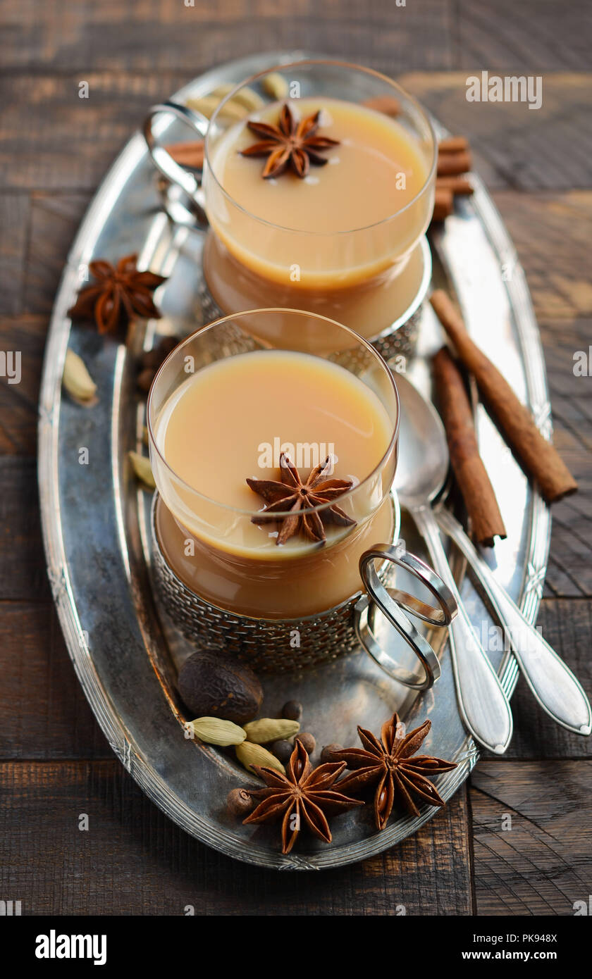 Indian masala chai tea. Spiced tea with milk in a vintage cups on the ...