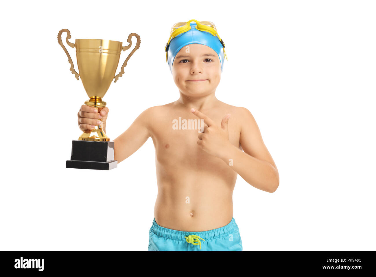 Young boy swimmer with a golden trophy pointing isolated on white ...