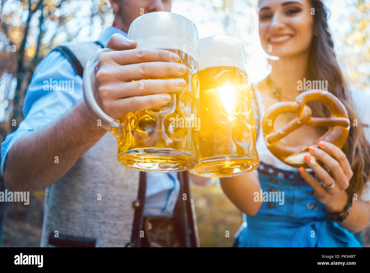 Couple toasting with beer in Bavaria Stock Photo - Alamy