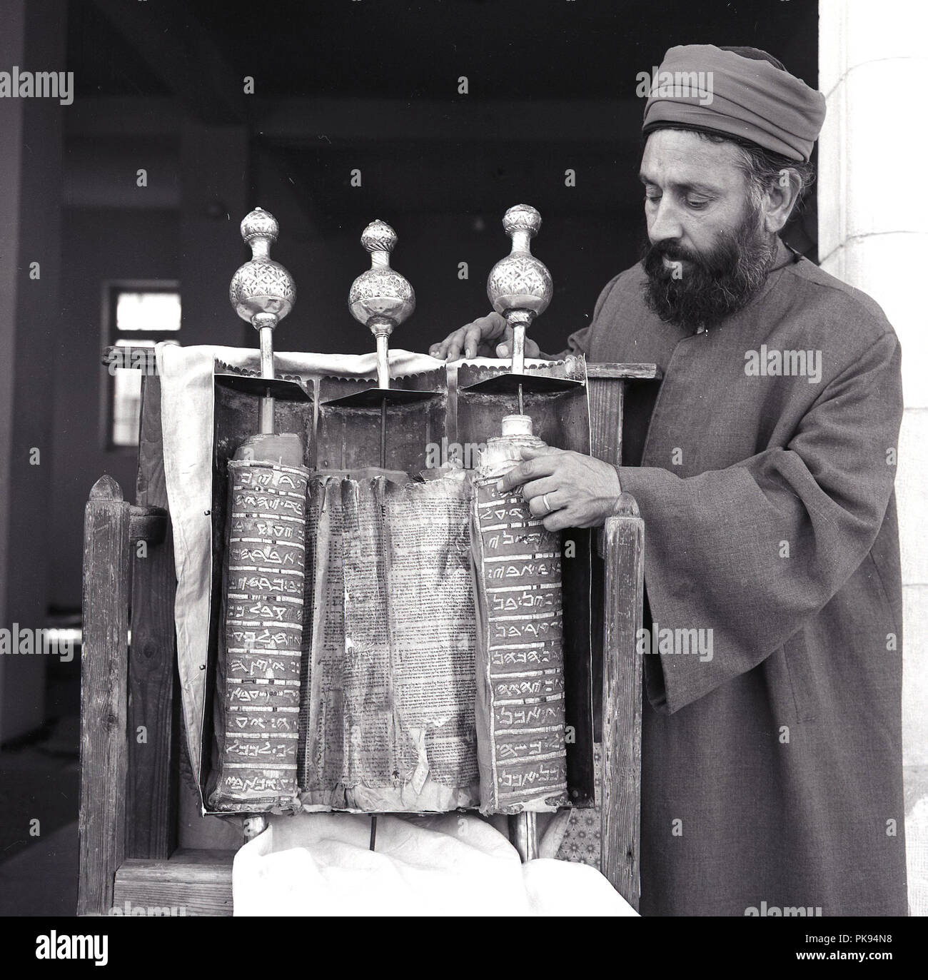 1950s, historical, an orthodox Turkish priest with ancient scrolls ...