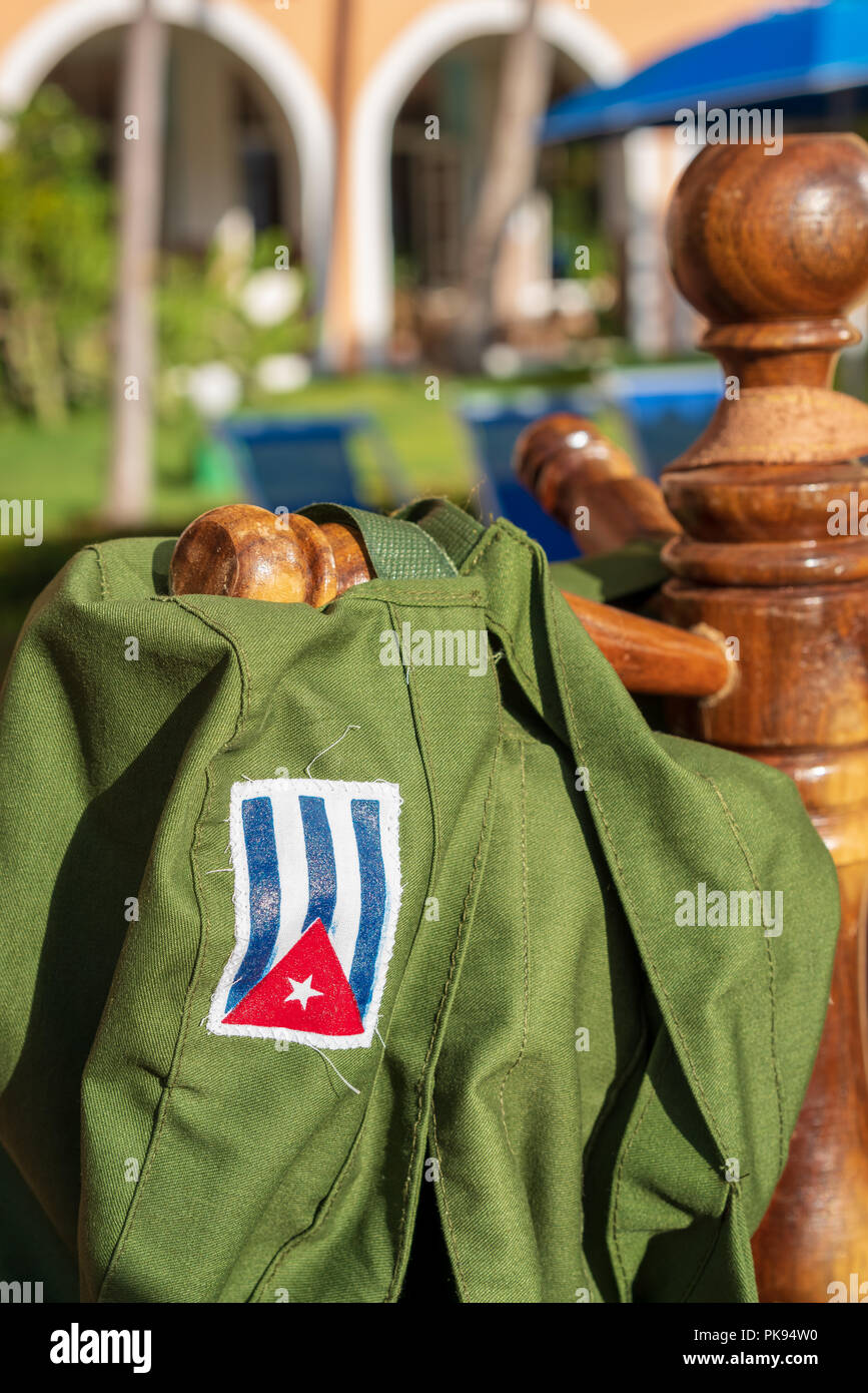 Green military hat with printed Cuban flag hanging in the sun, symbol ...