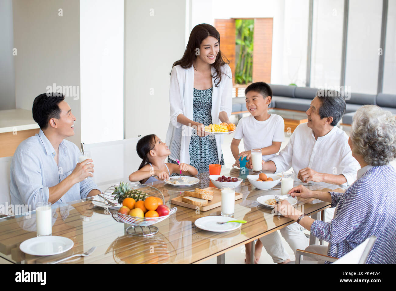 Happy family having breakfast Stock Photo - Alamy