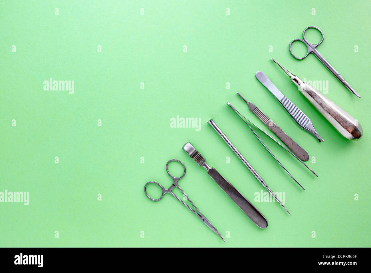 Medical equipments including surgical instruments on a green background ...