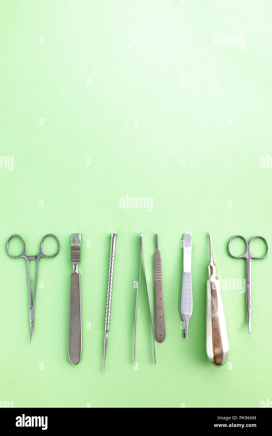 Medical equipments including surgical instruments on a green background ...