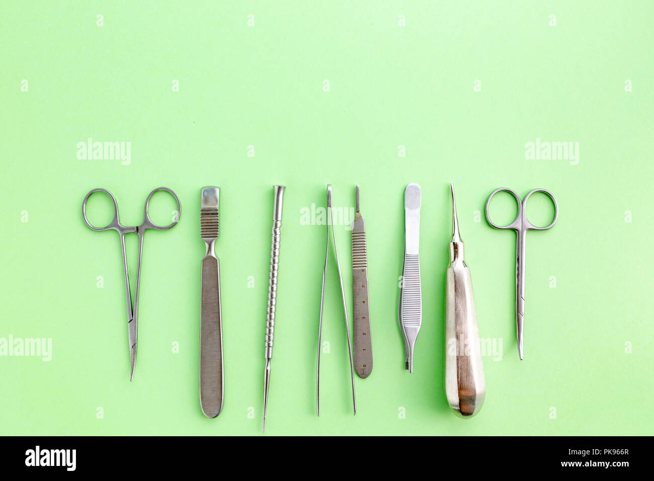 Medical equipments including surgical instruments on a green background ...