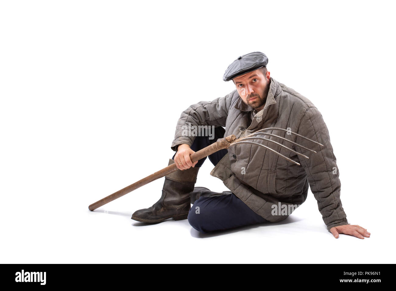 Peasant man with pitchfork on white background, serious concentrated ...