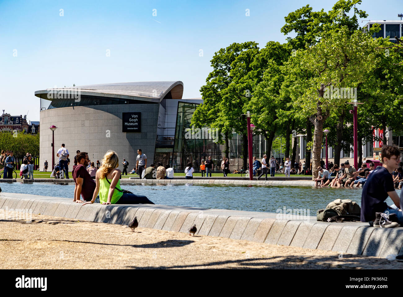 Tourists relaxing by the side of a pool, in the background the Van Gogh ...