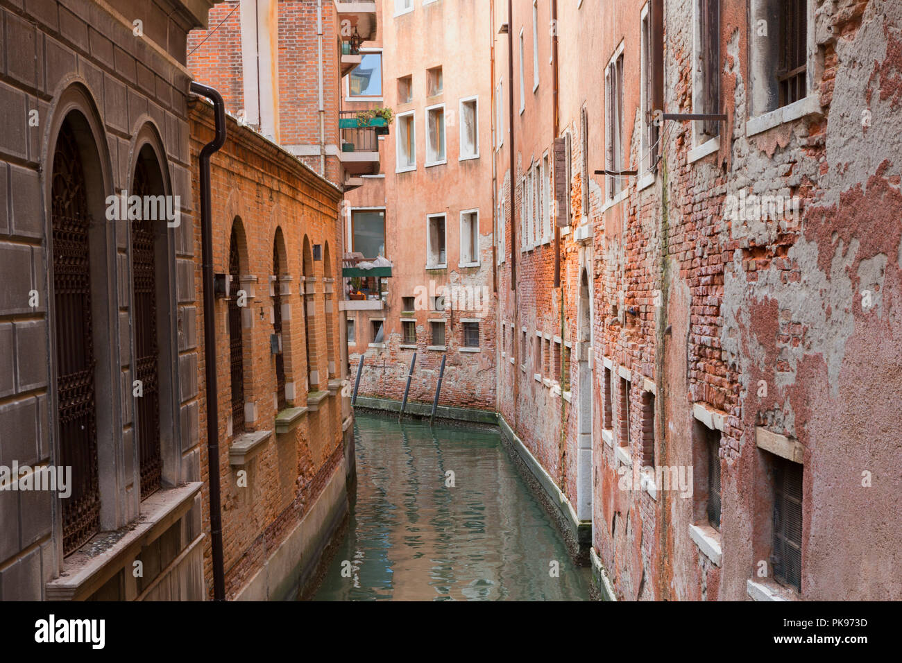 Canal in Venice, red brick wall old buildings, Italy Stock Photo - Alamy